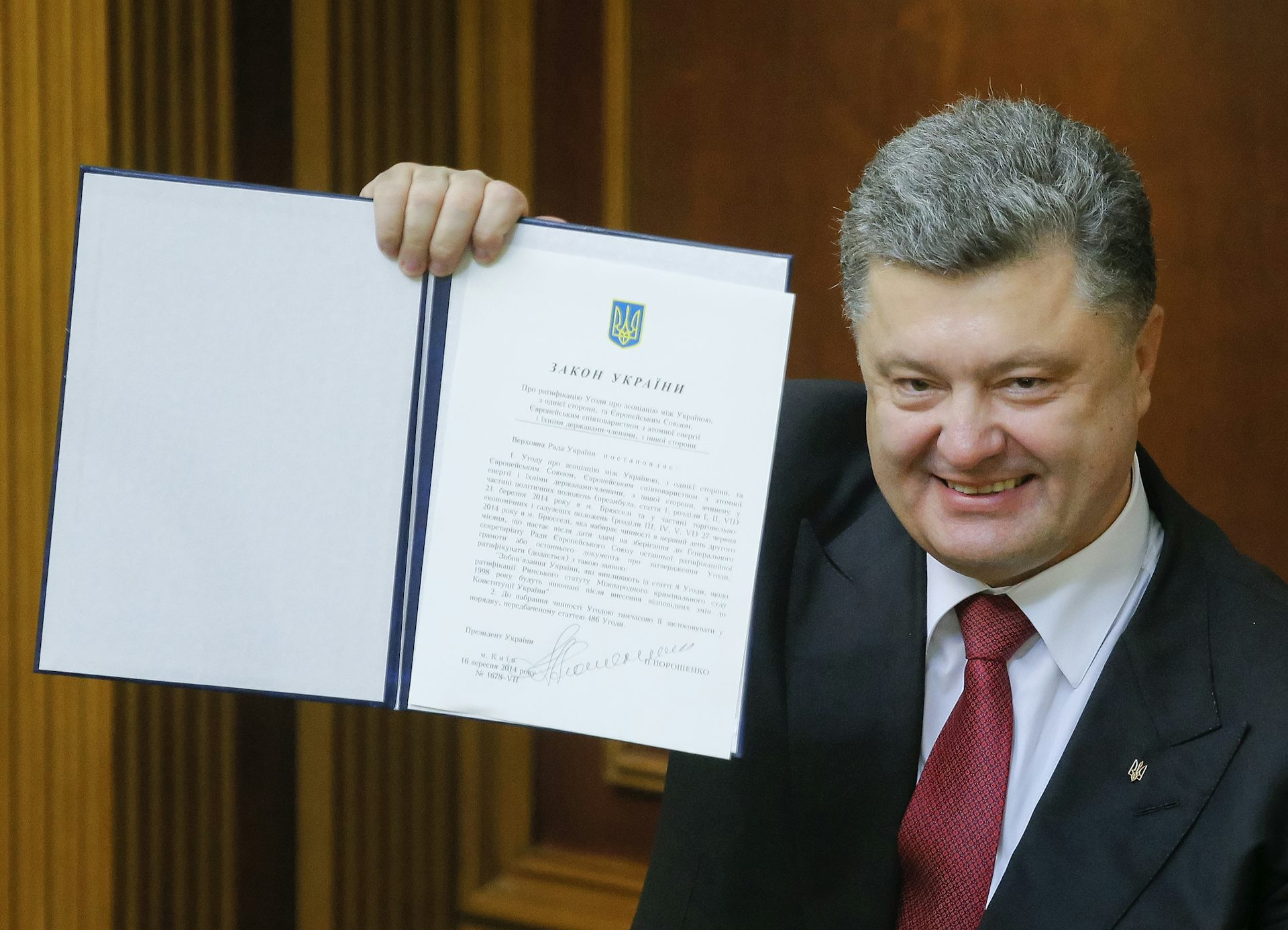 Restive Ukraine signs EU pact and hands rebels self-rule